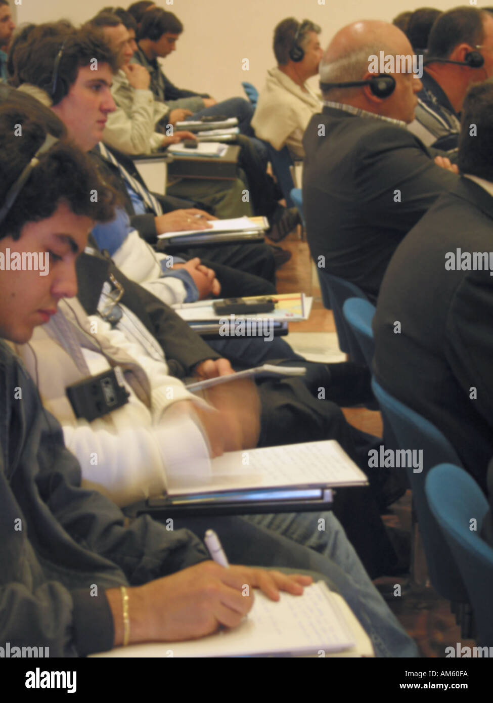 Businessmen at a conference wearing Language Translation Head Phones ...