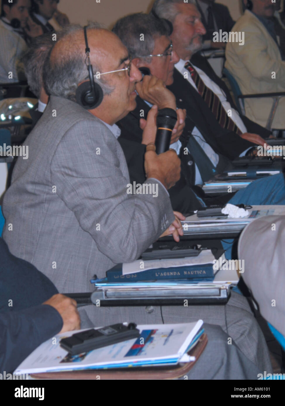Businessmen at a conference wearing Language Translation Head Phones ...