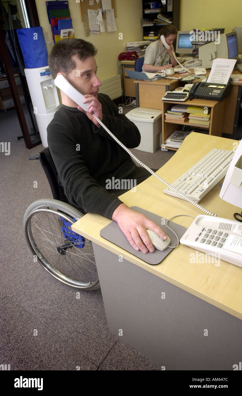 Disabled man at work in an office environment UK Stock Photo - Alamy
