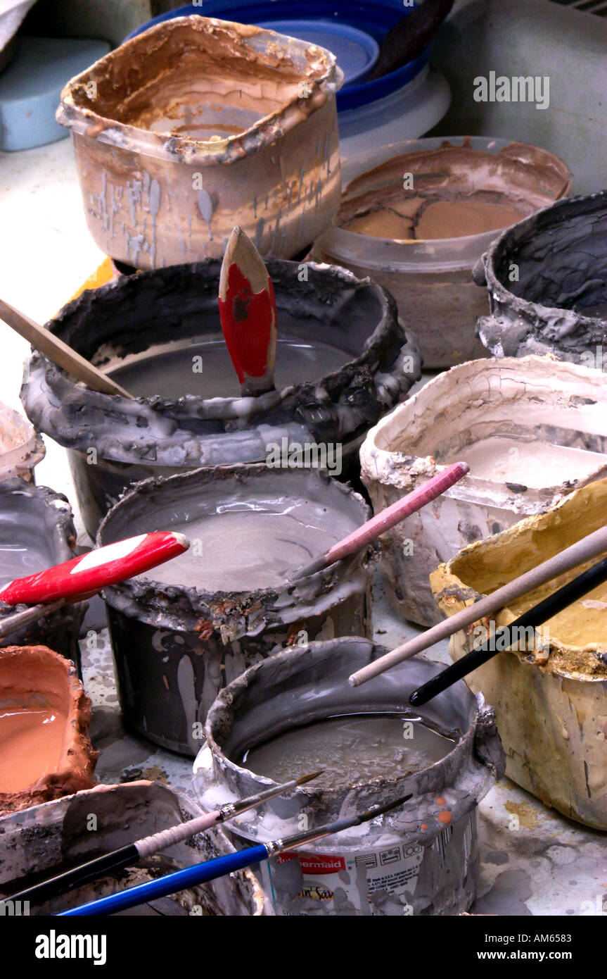 Containers of grey ceramic glazes used to color greenware prior to ...