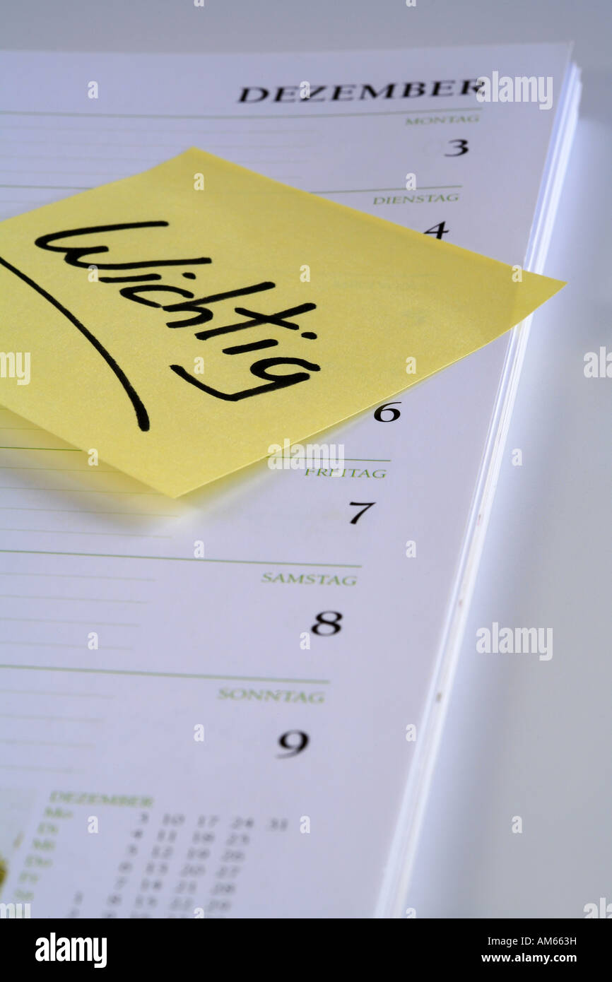 Yellow reminder note "Wichtig" (important) on the page of a calendar ...