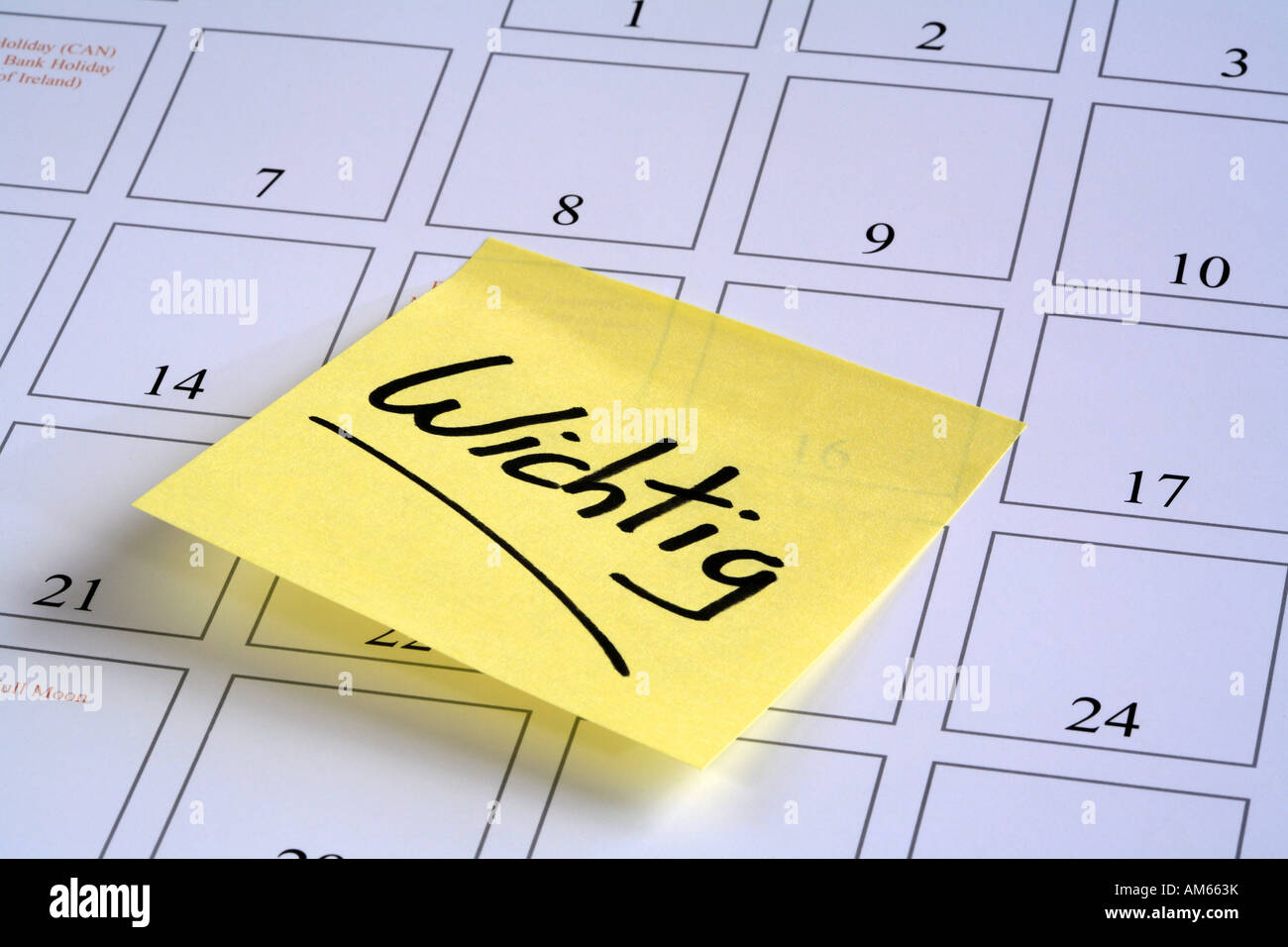 Yellow reminder note "Wichtig" (important) on the page of a calendar ...