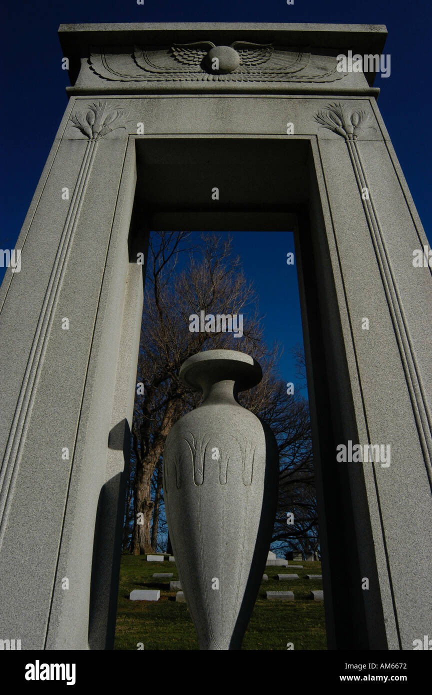 Carved stone arch and urn with Egyptian type engravings burial monument ...