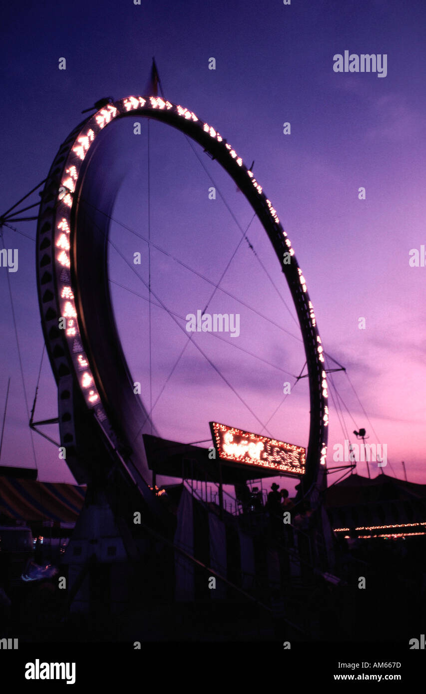 Circular amusement ride on a carnival midway at sunset Stock Photo - Alamy