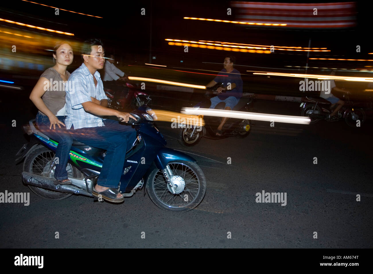 Two moped drivers in the streets of Saigon, Vietnam, Asia Stock Photo ...