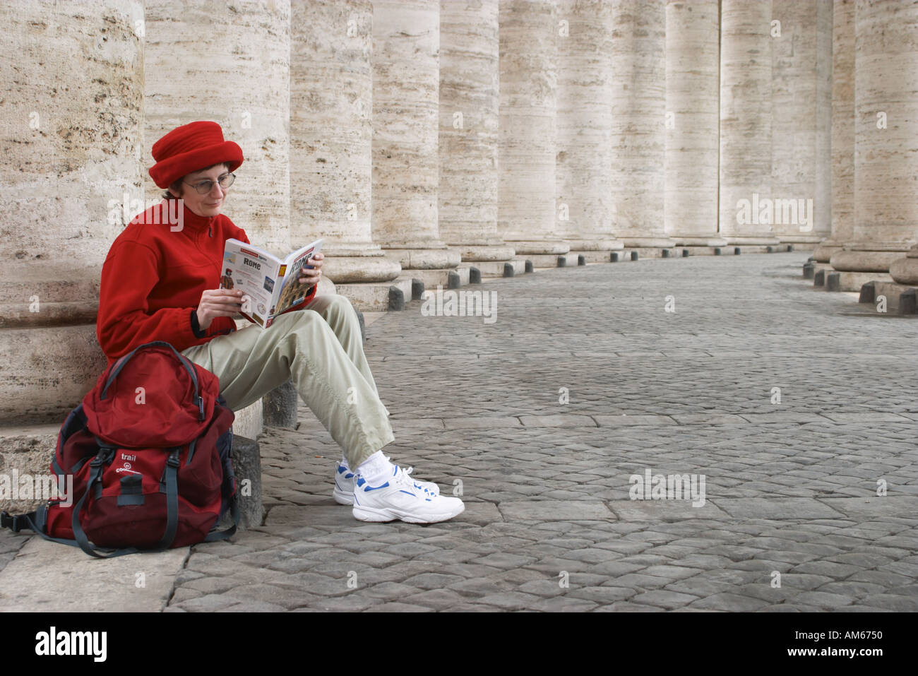 A tourist reads a guide book to Rome at Piazza San Pietro (Saint Peter ...