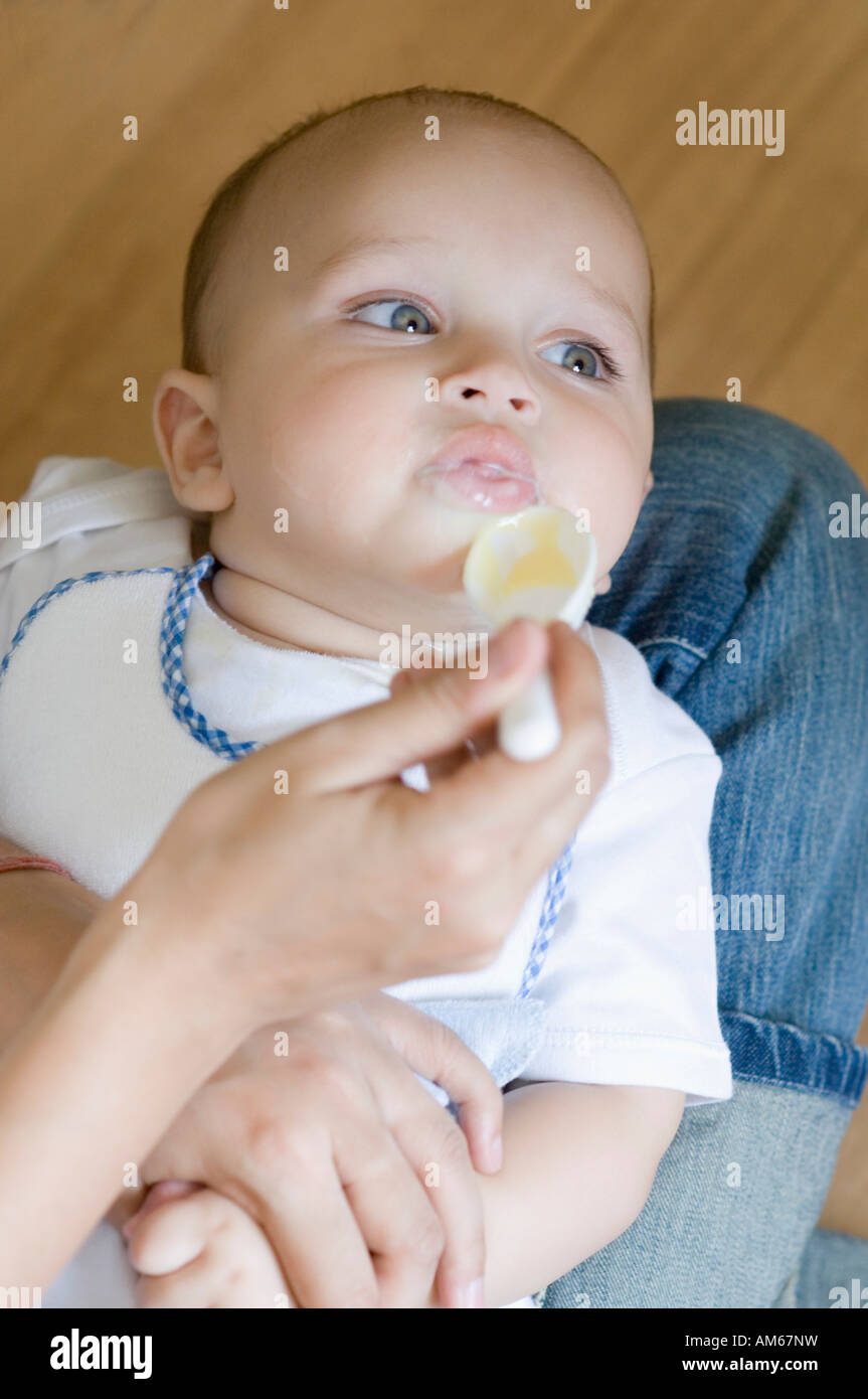 Close-up of a person's hand feeding food to a baby boy Stock Photo - Alamy