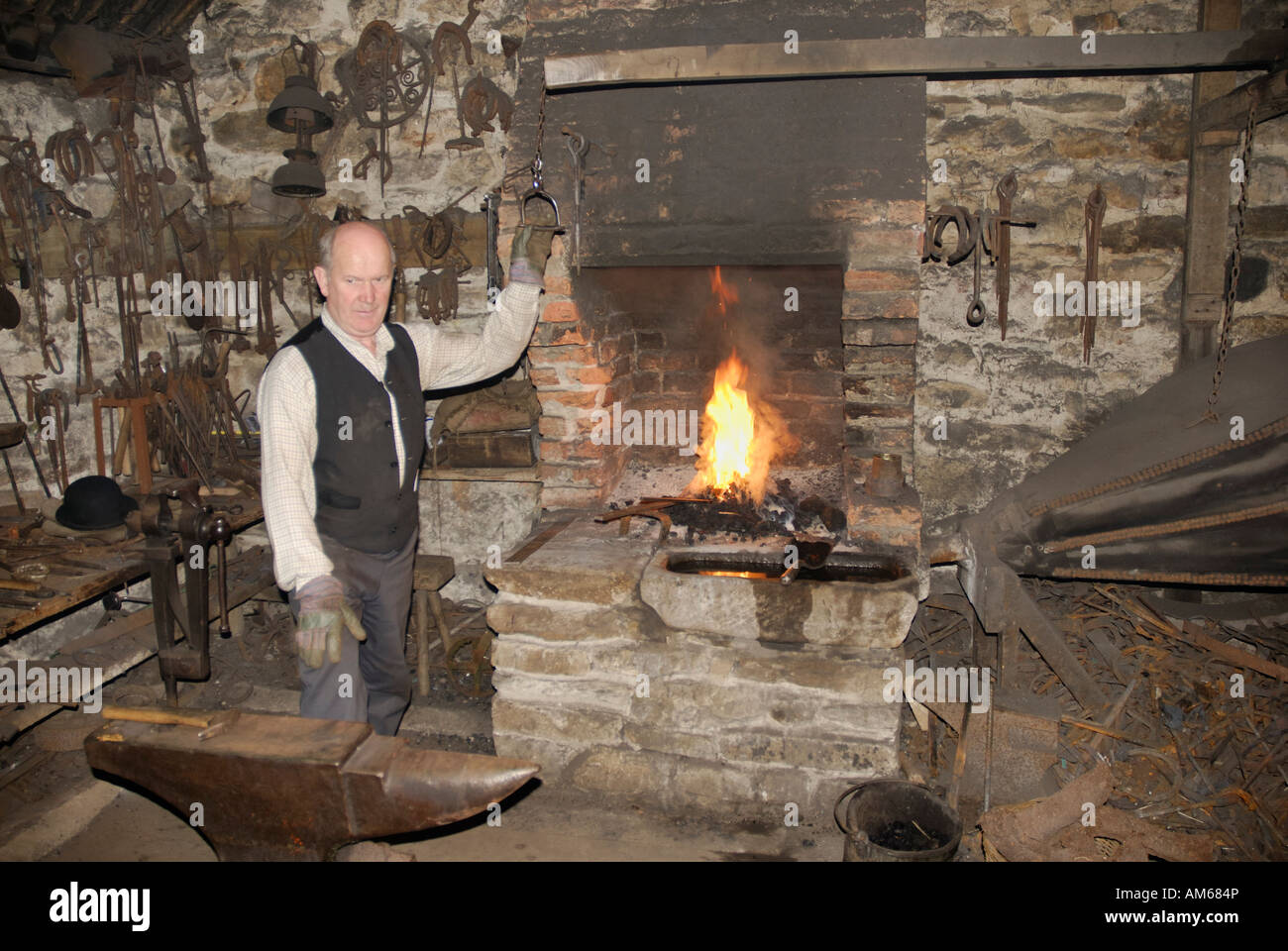 Farrier in historic workshop demonstrating his craft, Ulster American ...