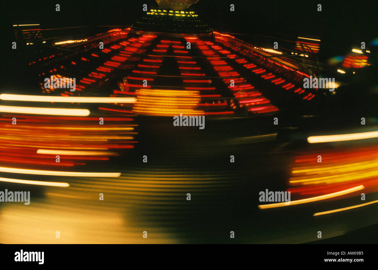 Light trails from a fairground carousel England UK Stock Photo - Alamy