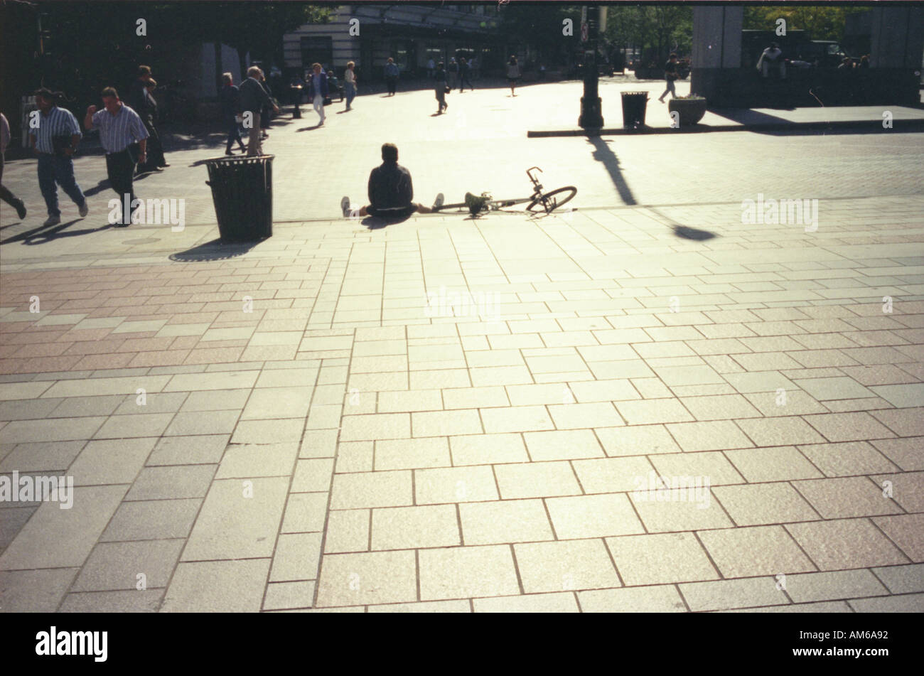 Bicyclist sitting on a curb Stock Photo - Alamy