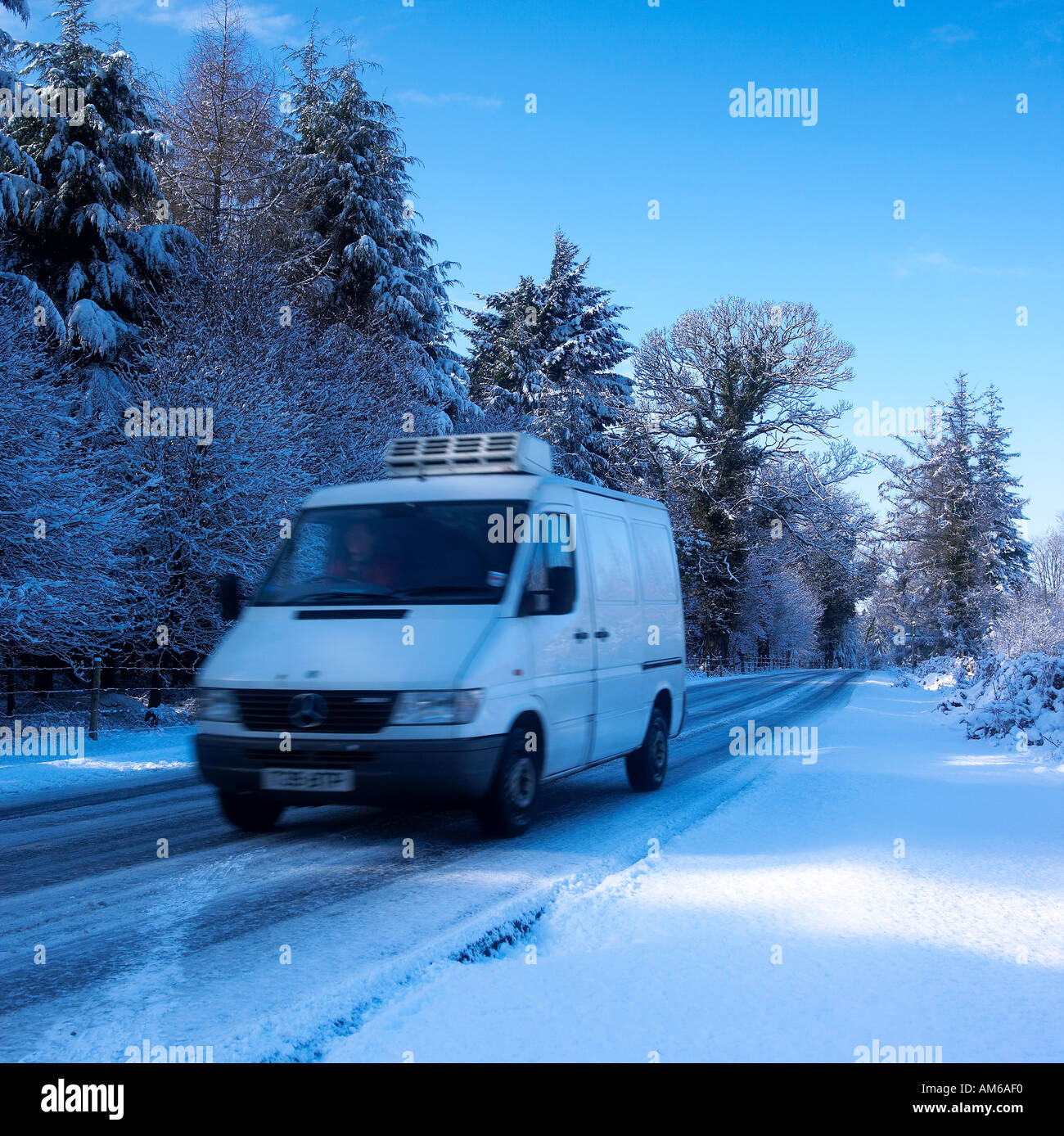 A snowy road scene Stock Photo - Alamy