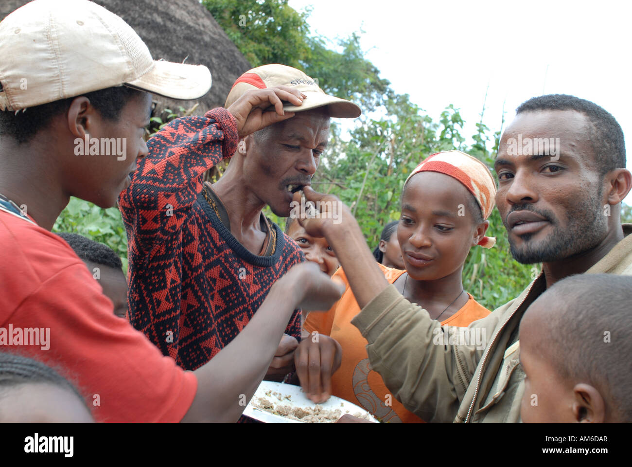 Ethiopian men and women eating lunch cabbage and enset false banana ...