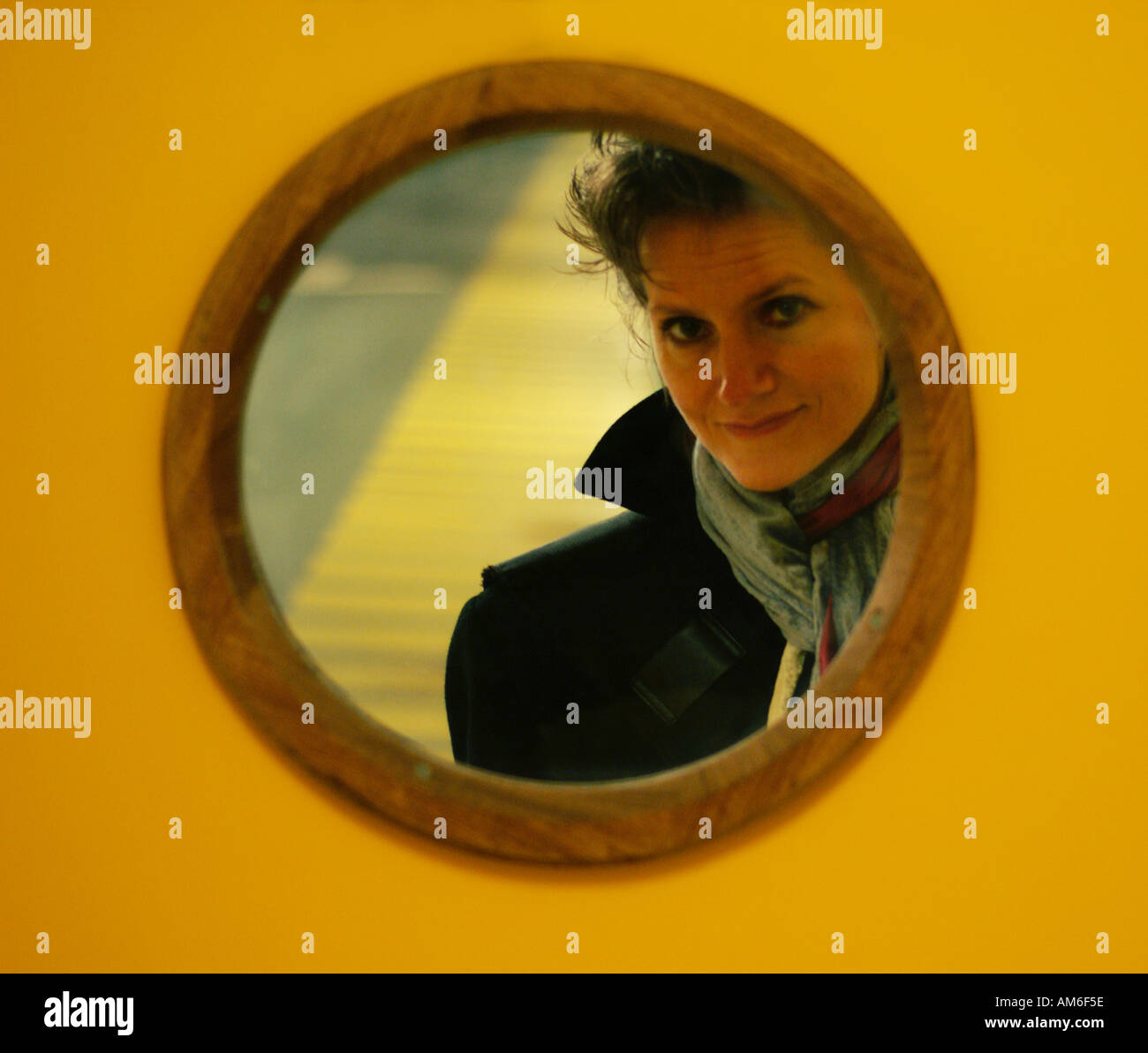 Woman looking window porthole hi-res stock photography and images - Alamy