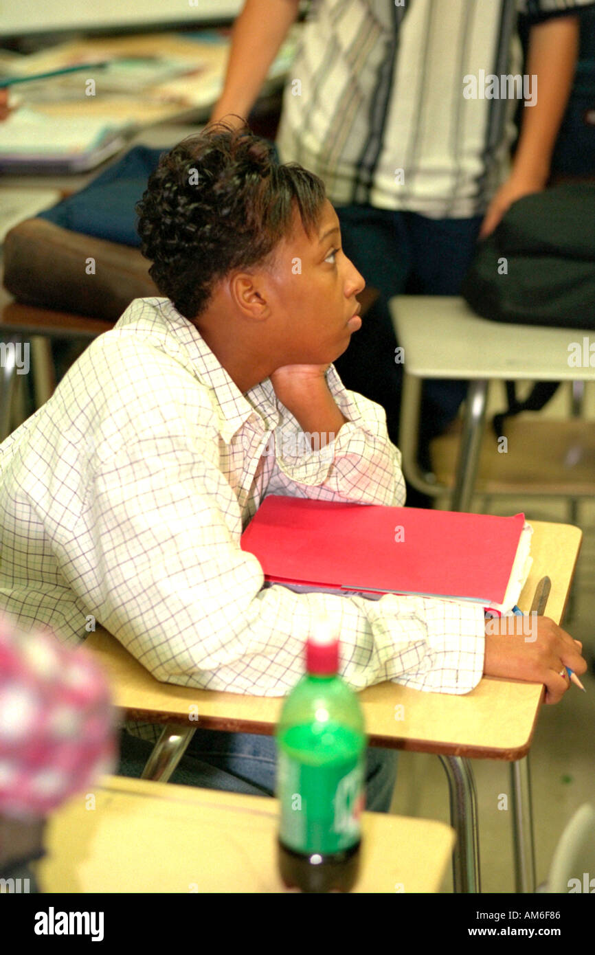 African American teen girl age 15 sitting in high school classroom. New ...