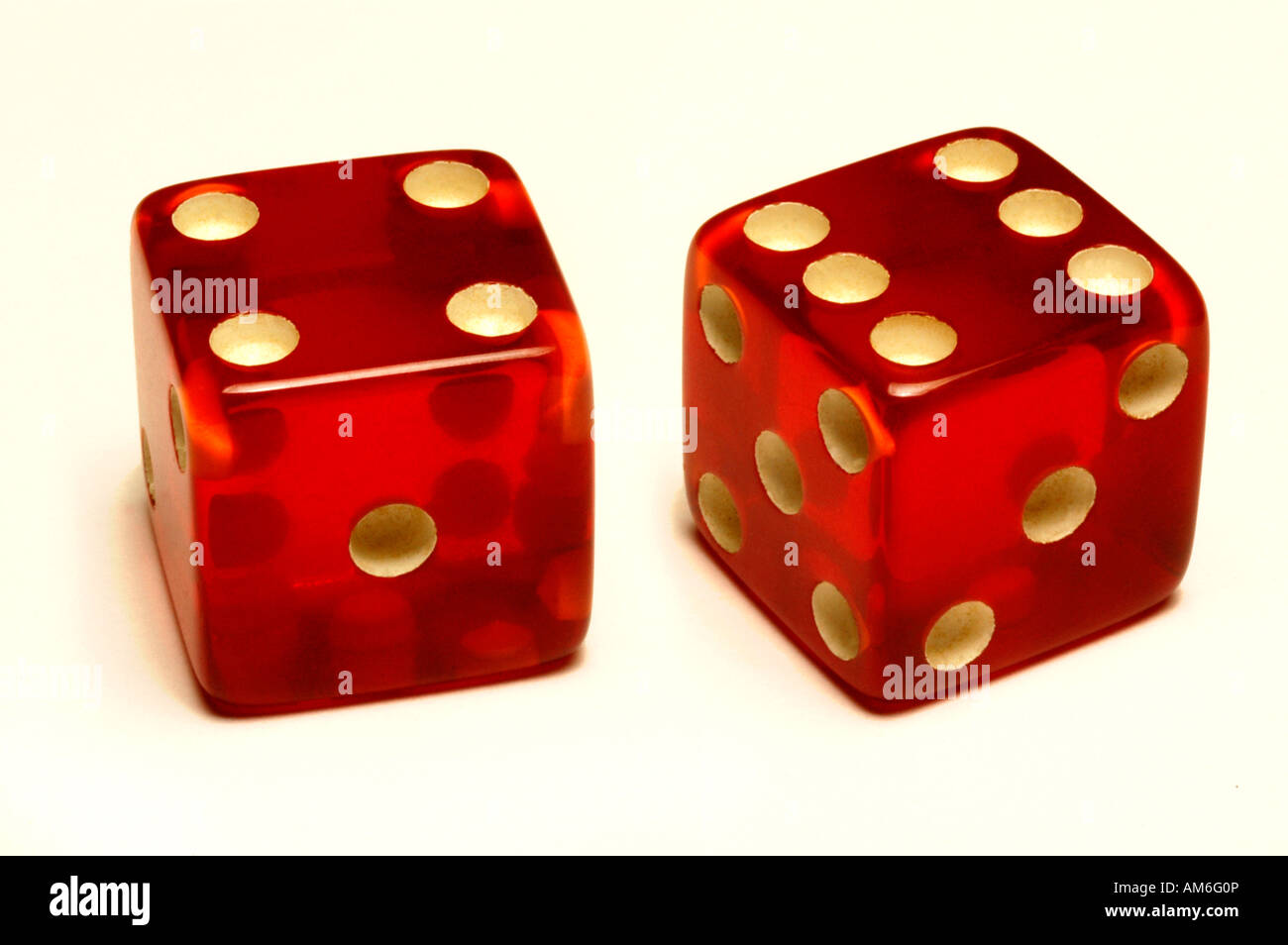 Two red dice on a white surface Stock Photo - Alamy