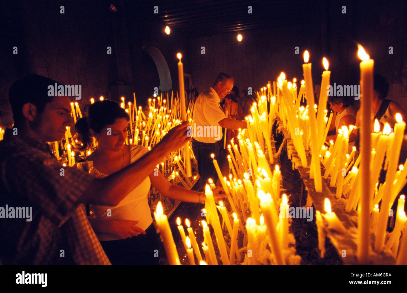 El Rocio pilgrims burning candles in the church of the holy virgin ...