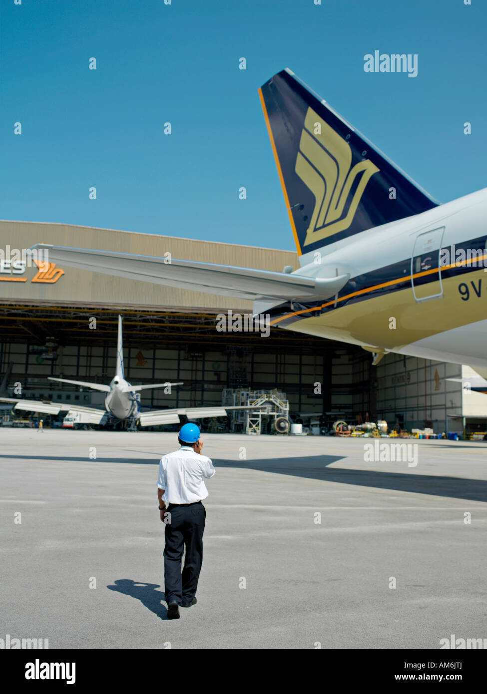 Workers in a maintenance aviation facility at the SIA Engineering ...