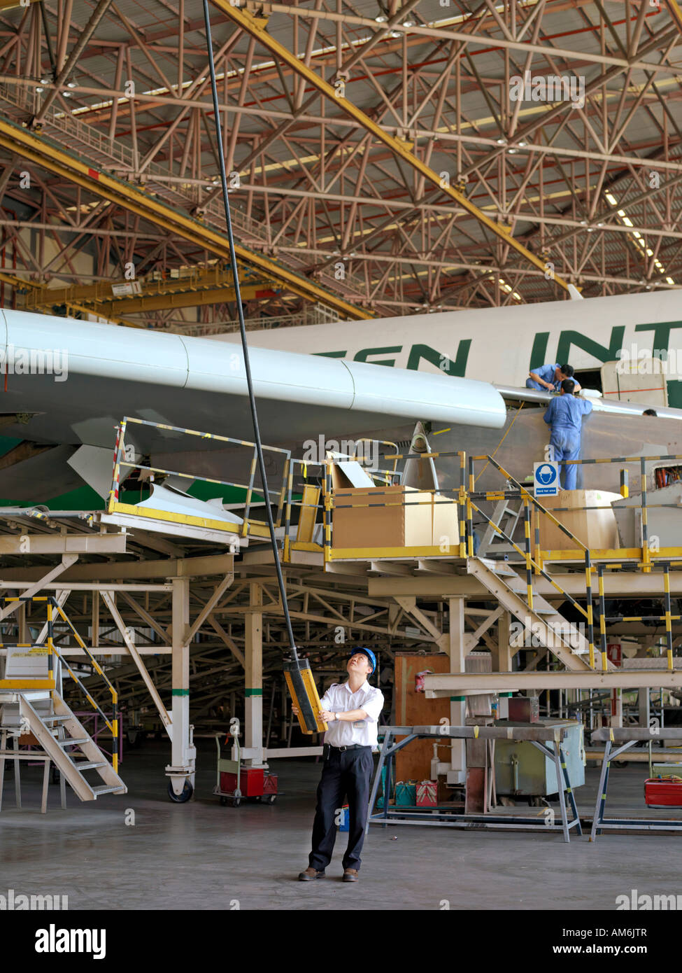 Workers in a maintenance aviation facility at the SIA Engineering ...