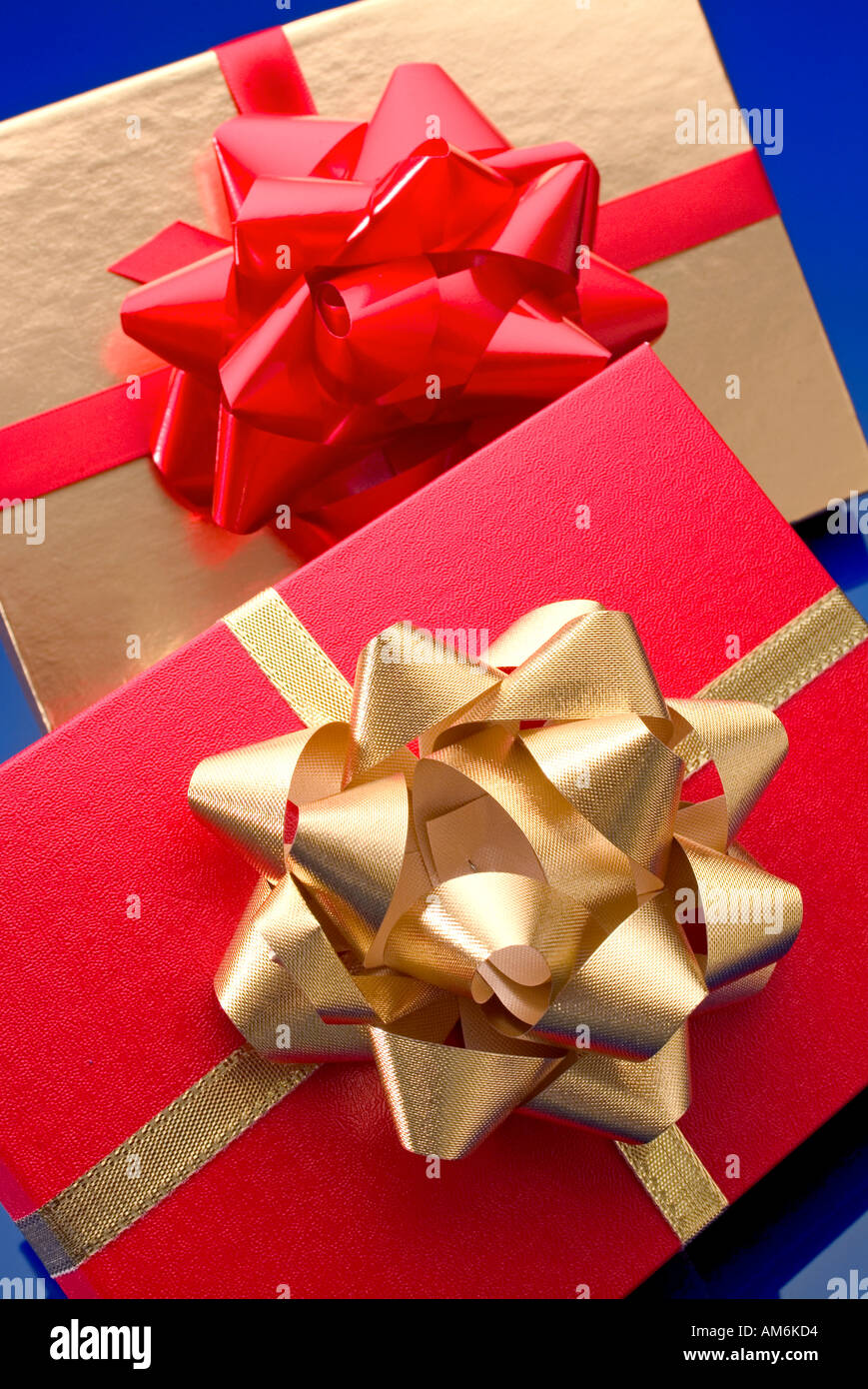 Gold gift box with red ribbon and red box with gold bow Stock Photo - Alamy