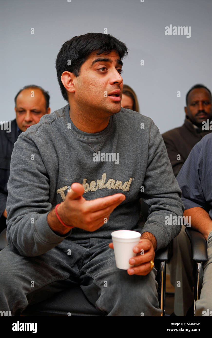 Asian man public speaking, Hounslow, Middlesex, UK Stock Photo - Alamy