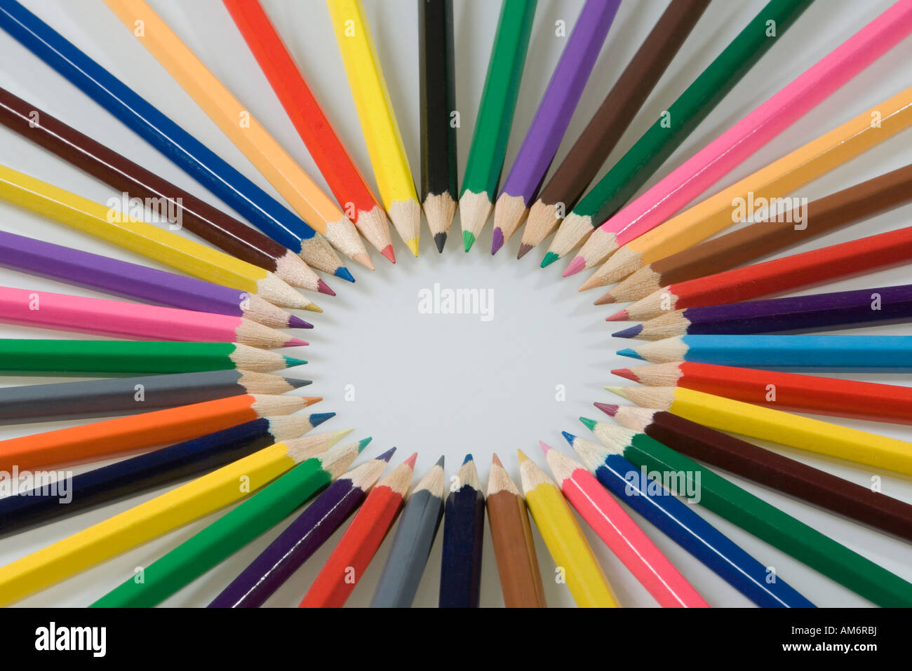 Colored pointed pencils arranged in a circle taken with a low angle ...