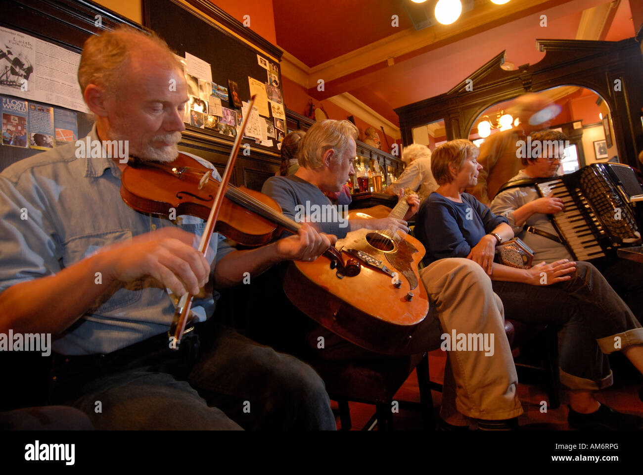 musicians enjoying an open folk music session at the Sandy's bell pub ...