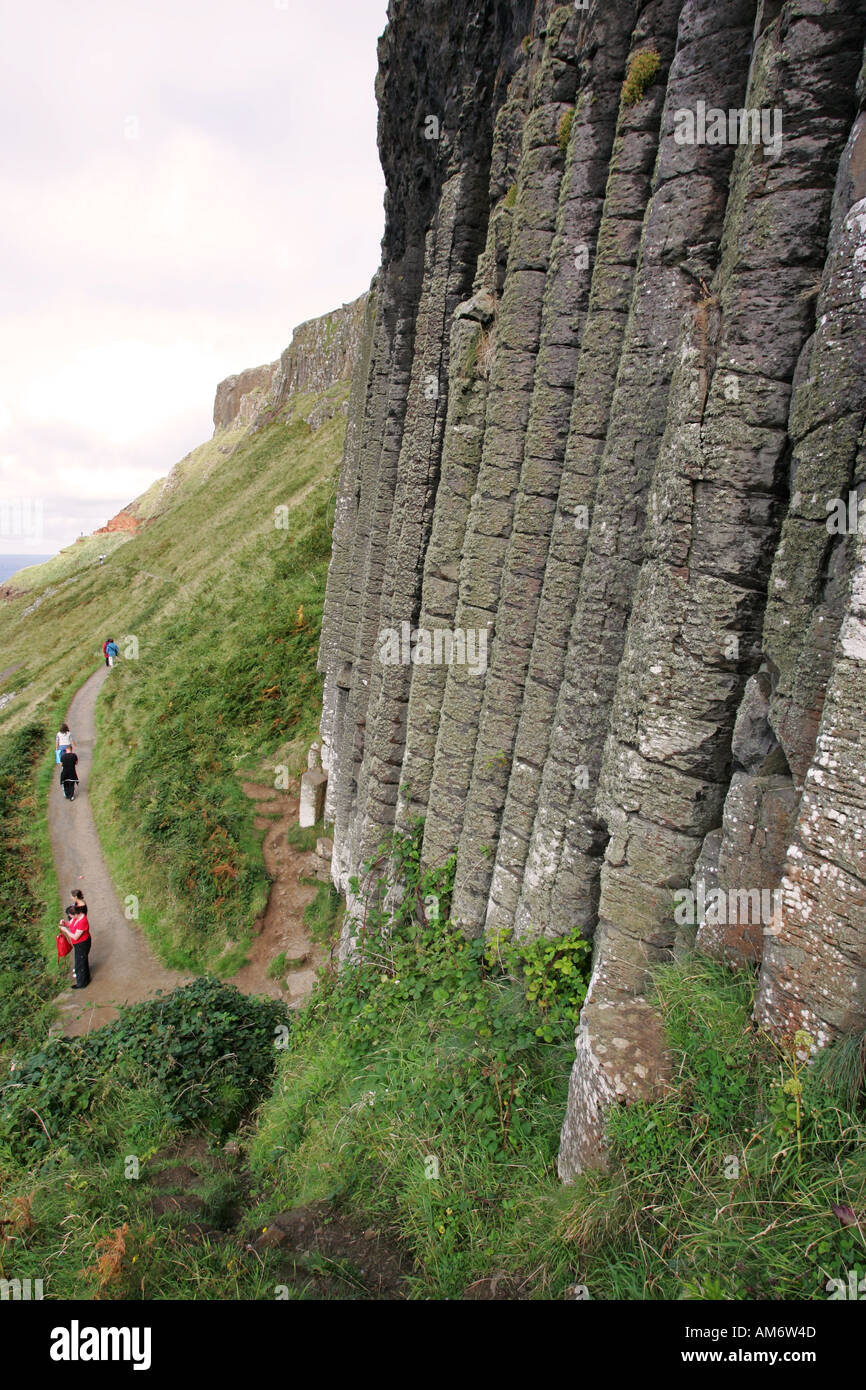 Tourists walk along the Causeway coastal path near the Giants Organ ...