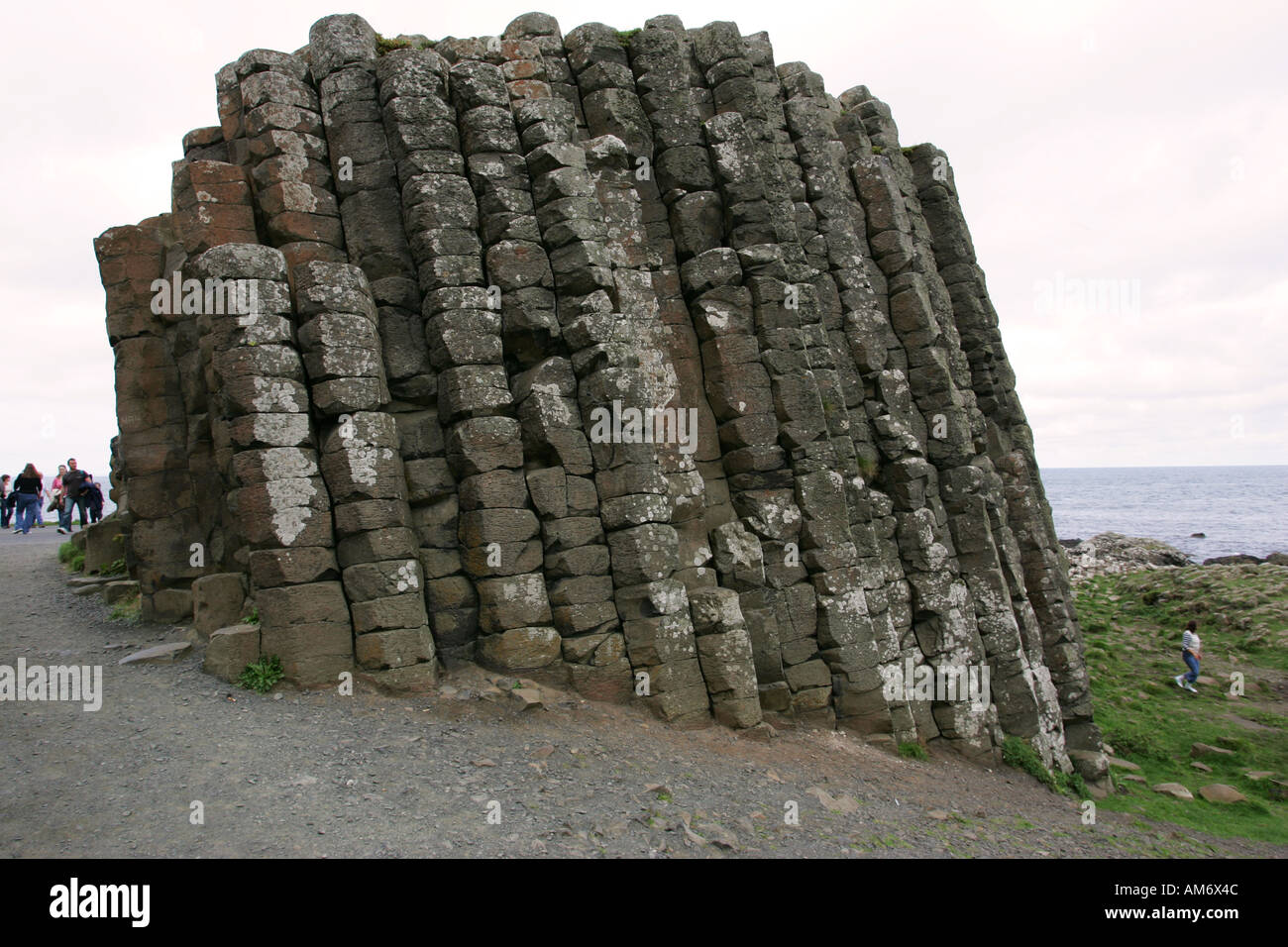 Huge tall stacks of basalt rock tower over tourists visiting the Giants ...