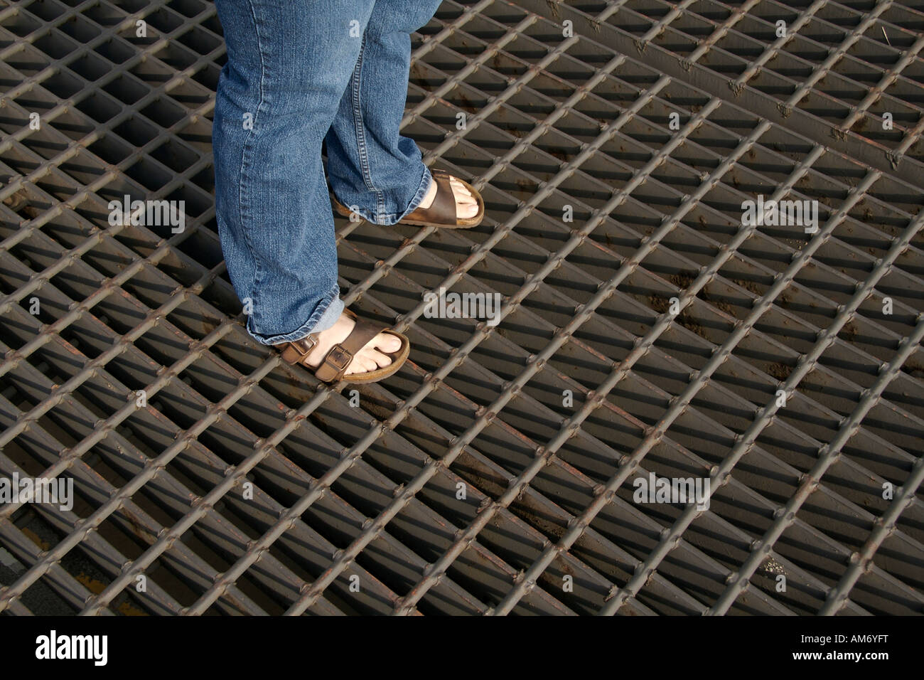 Woman standing on grate Stock Photo - Alamy