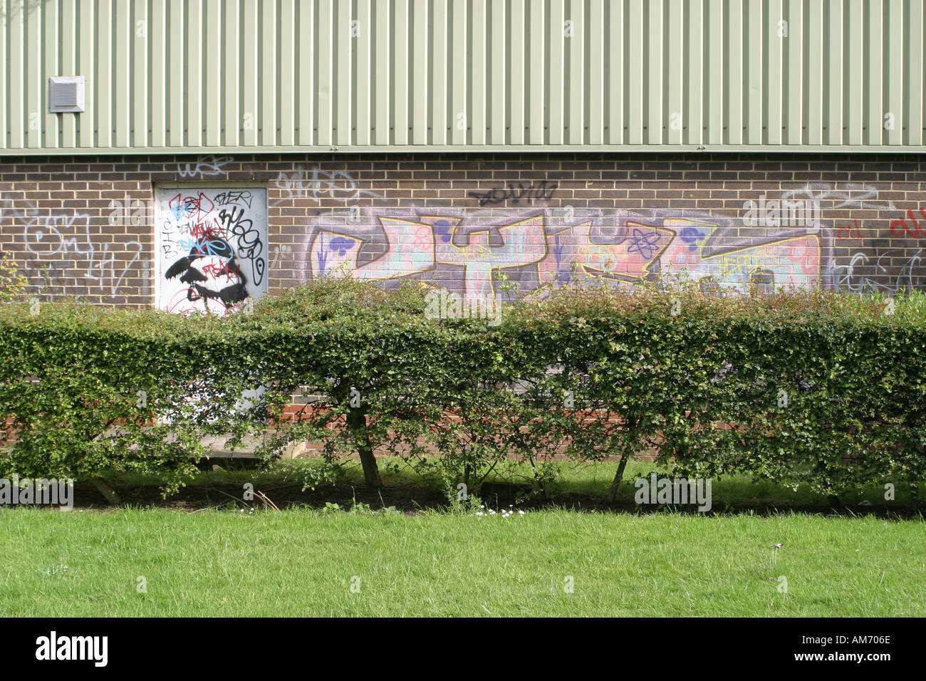 The graffiti covered side of a warehouse on an industrial estate in ...