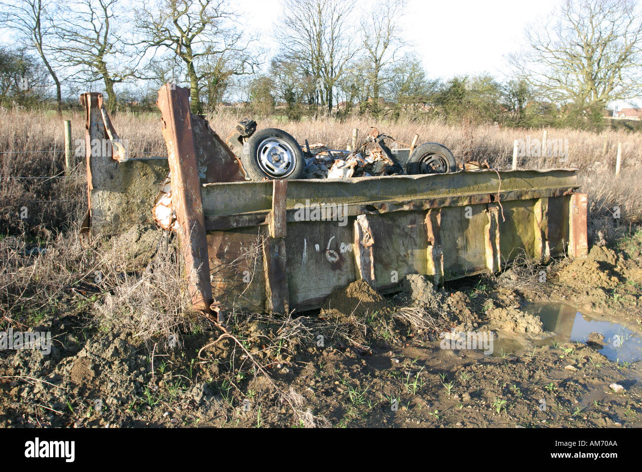 A wrecked car recovered from waste land and thrown in a skip Stock ...