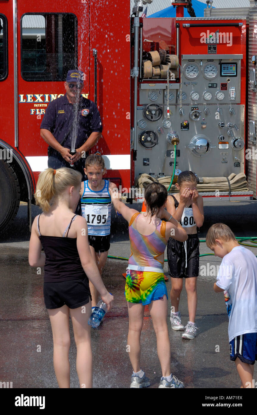 Children Being Sprayed by a Fire Hose on a Hot Summer Day Stock Photo ...