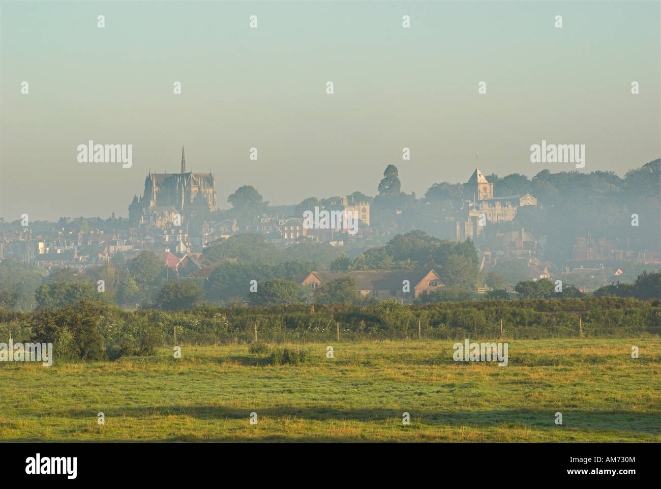 A misty scene in the Arun Valley with Arundel Town and Cathedral in the ...