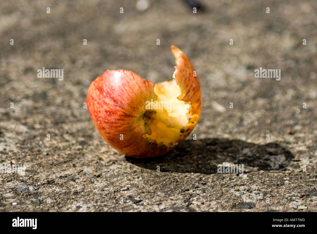 Apple half eaten by birds Stock Photo - Alamy