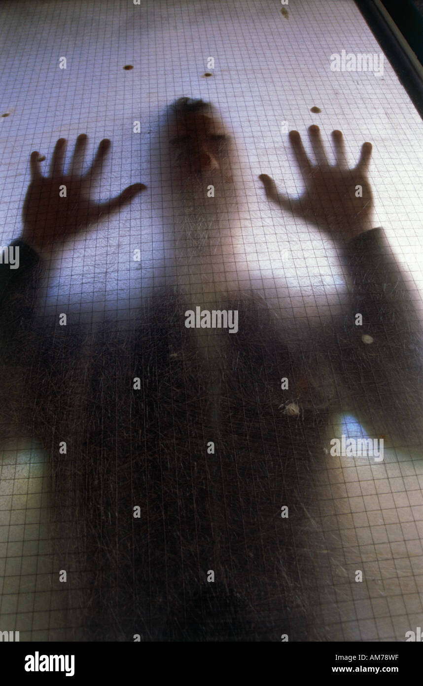 A man pressing up against a glass window Stock Photo - Alamy