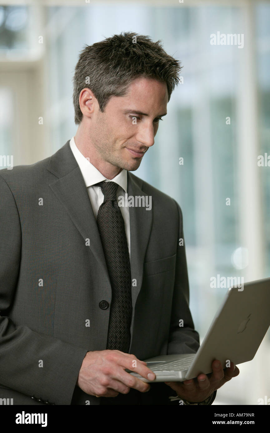 Man in suit with laptop Stock Photo - Alamy