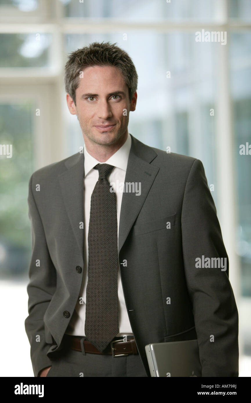 Man in suit with laptop Stock Photo - Alamy