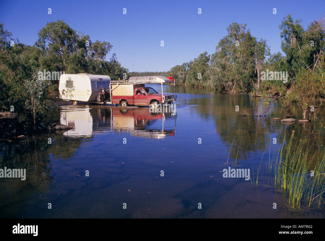 4WD vehicle with caravan crossing Calvert River Gulf Region Northern ...