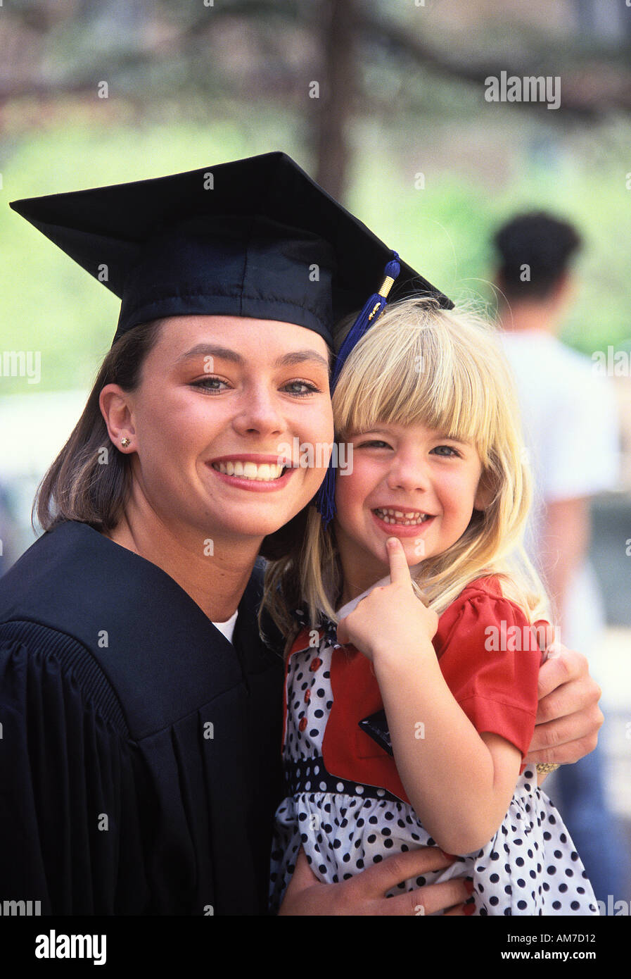 female graduate with her little sister Stock Photo - Alamy