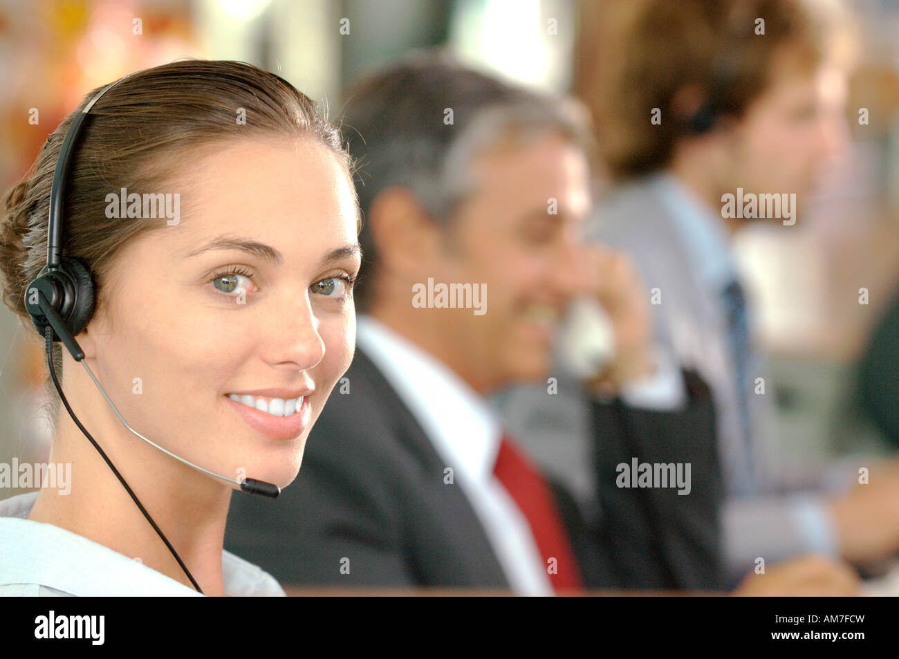 Businesswoman wearing headset, smiling, side view Stock Photo - Alamy