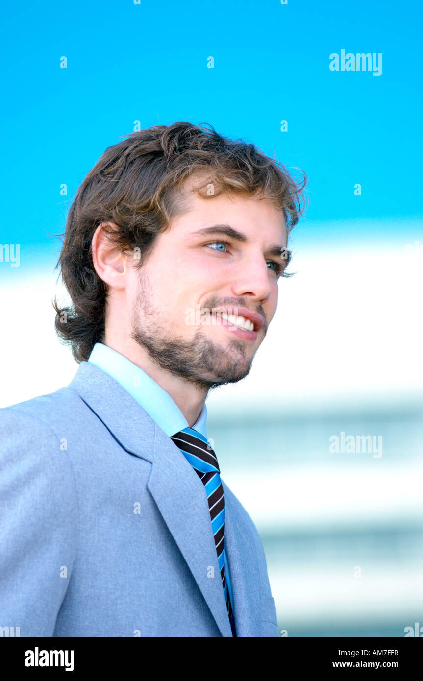 Young businessman smiling, side view Stock Photo - Alamy