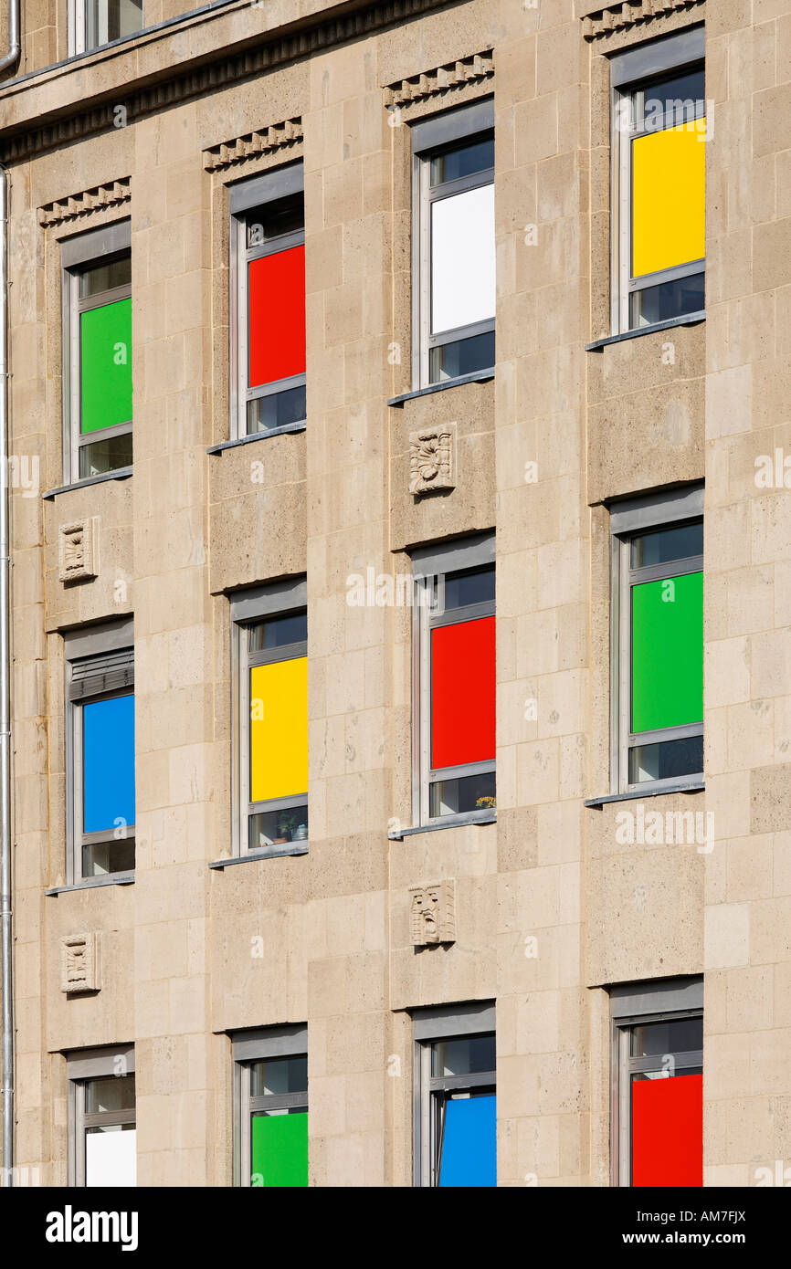 Front windows of a building, sticked with colourful wrappers ...