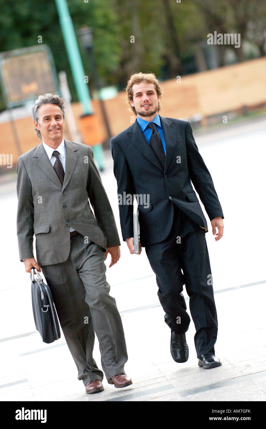 Businessmen walking on street Stock Photo - Alamy