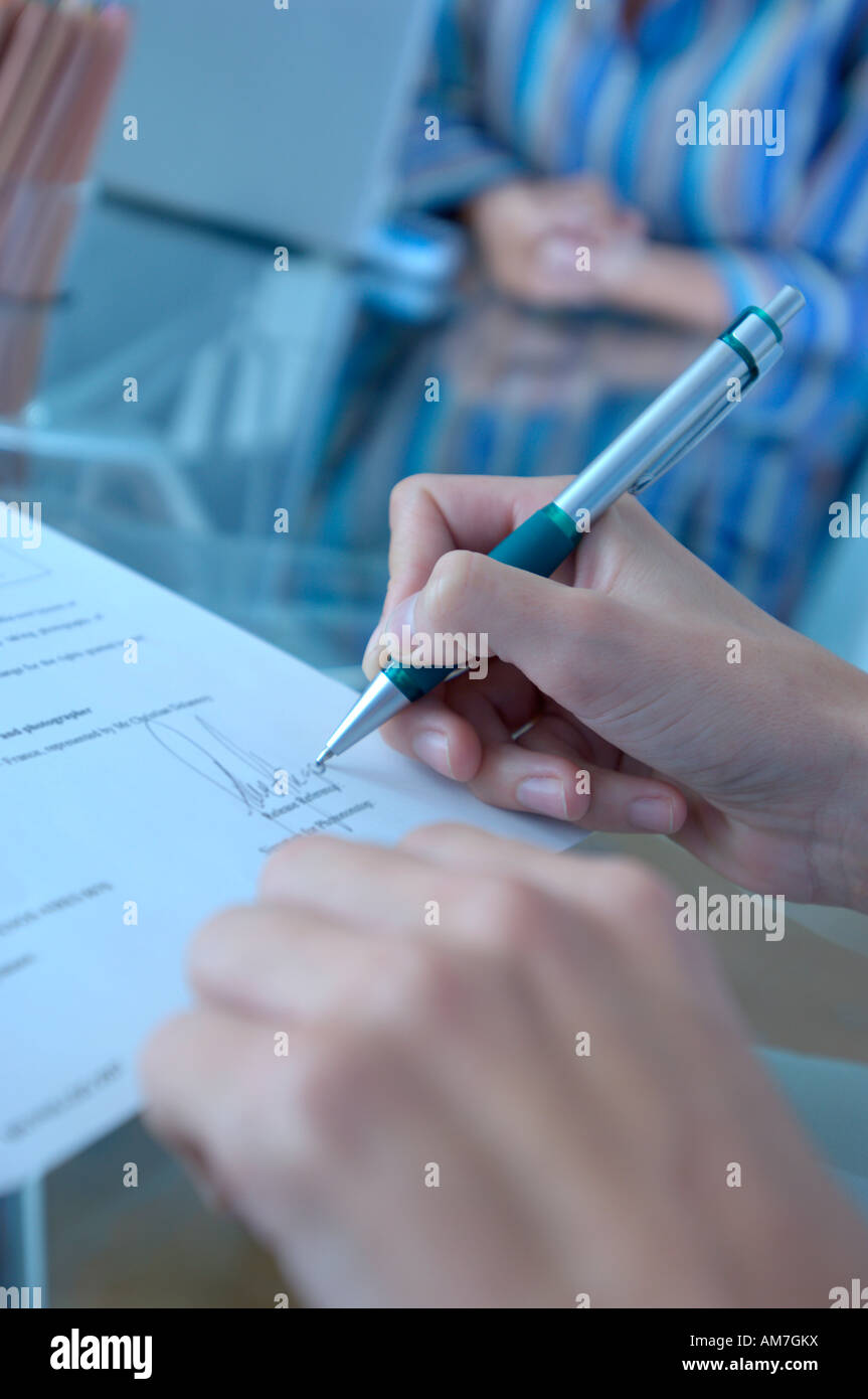 Person signing on document, close-up Stock Photo - Alamy