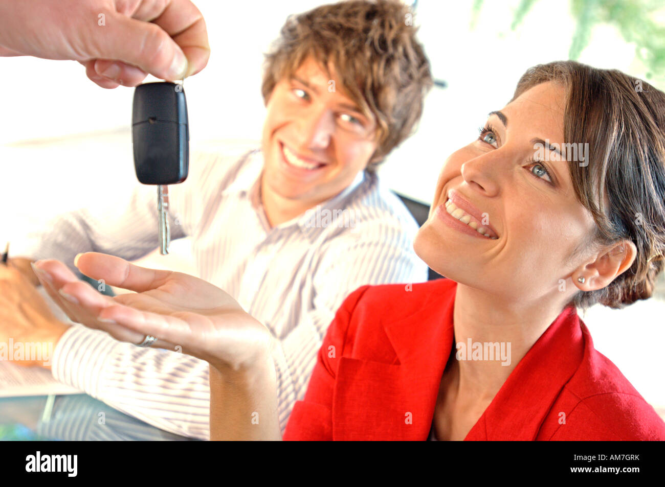Car dealer handing car key to customer, smiling Stock Photo - Alamy