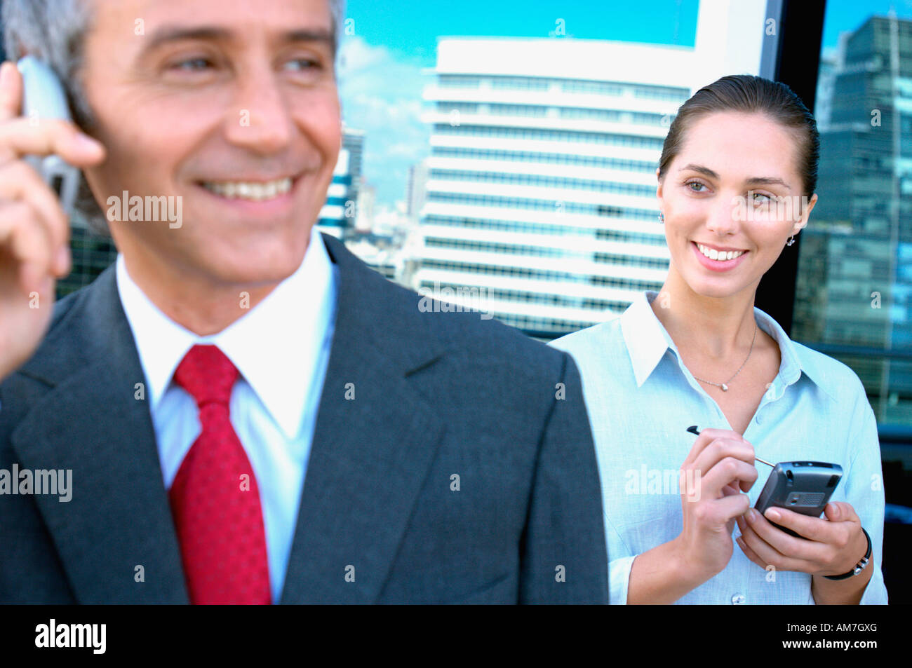 Business people using mobile phone, smiling Stock Photo - Alamy