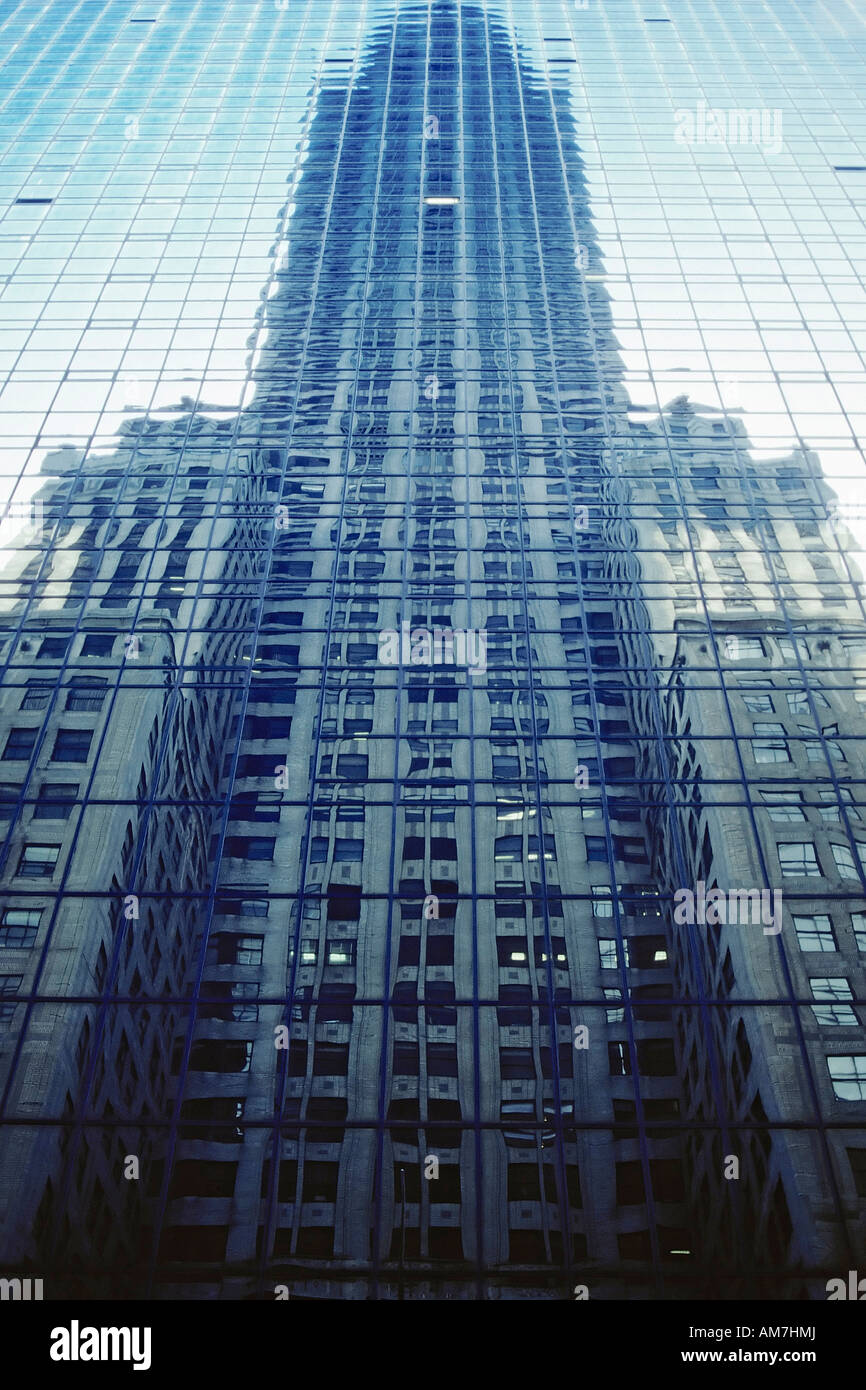 High-rise reflecting into a modern glass front, New York City, USA ...