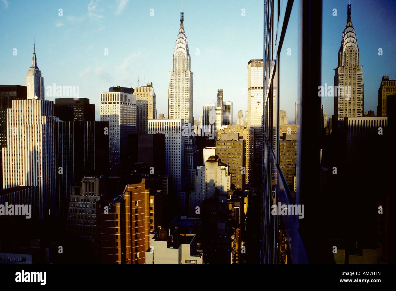Skyline with Chrysler Building reflecting in the glass front of the ...