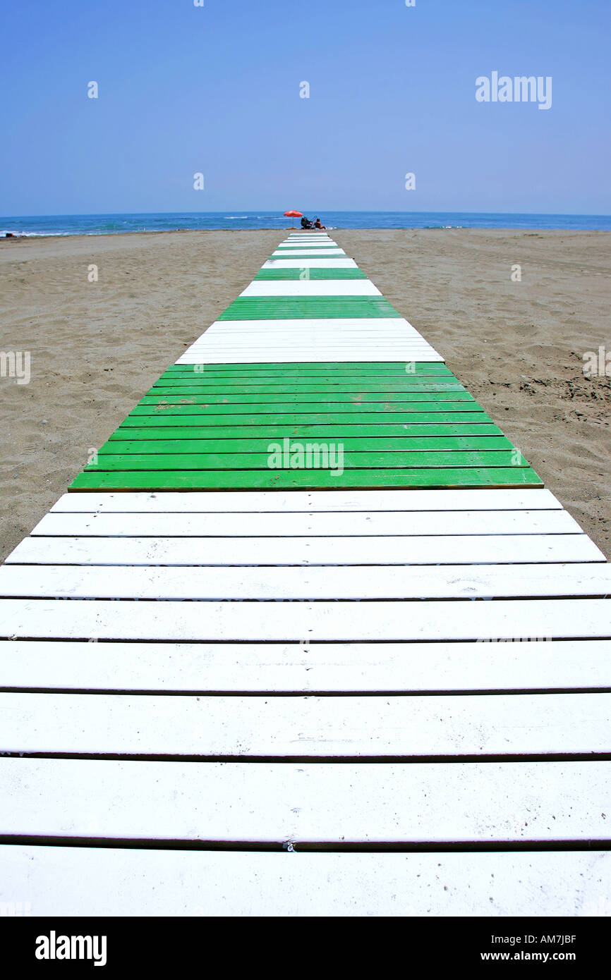 Green and white striped wooden walkway leading to beach in Spain Stock ...