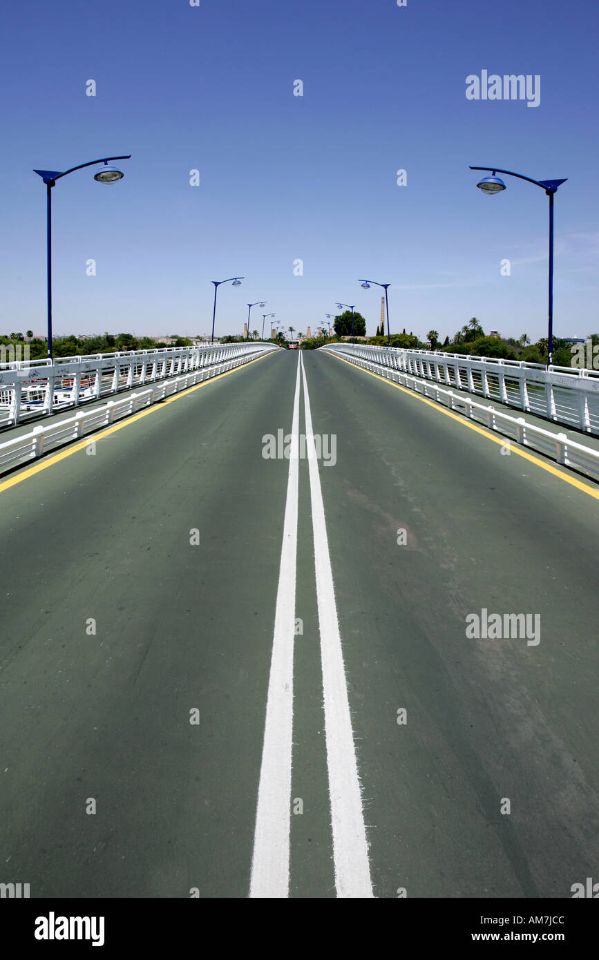 Fading lines of long road bridge over the river Guadalquivir in Seville ...